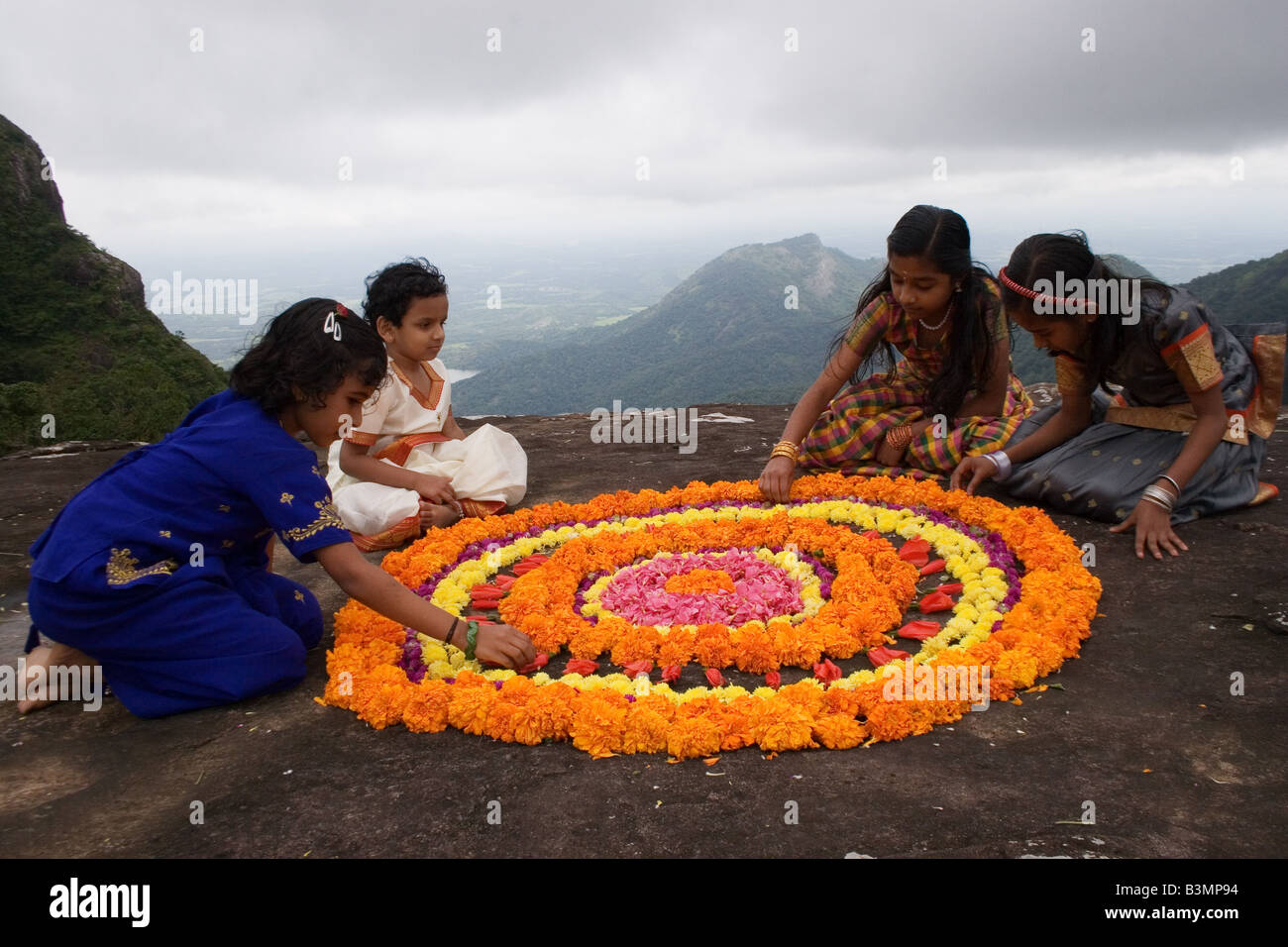 Children arranging floral carpet for onam Stock Photo - Alamy