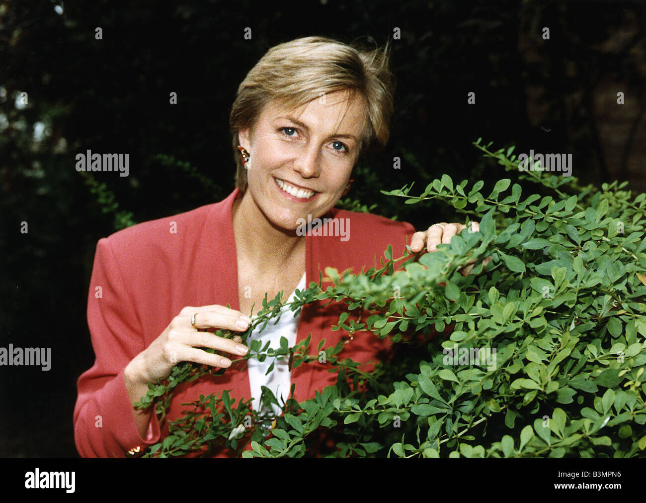 Jill Dando TV Presenter standing behind a bush Stock Photo - Alamy