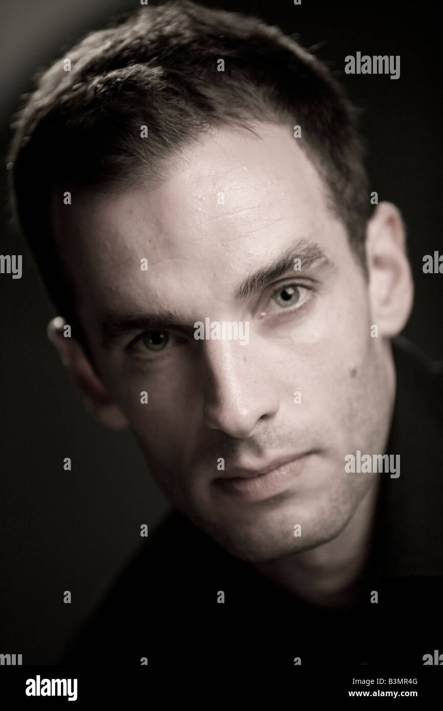 male model looks into camera classic portrait lighting Stock Photo - Alamy