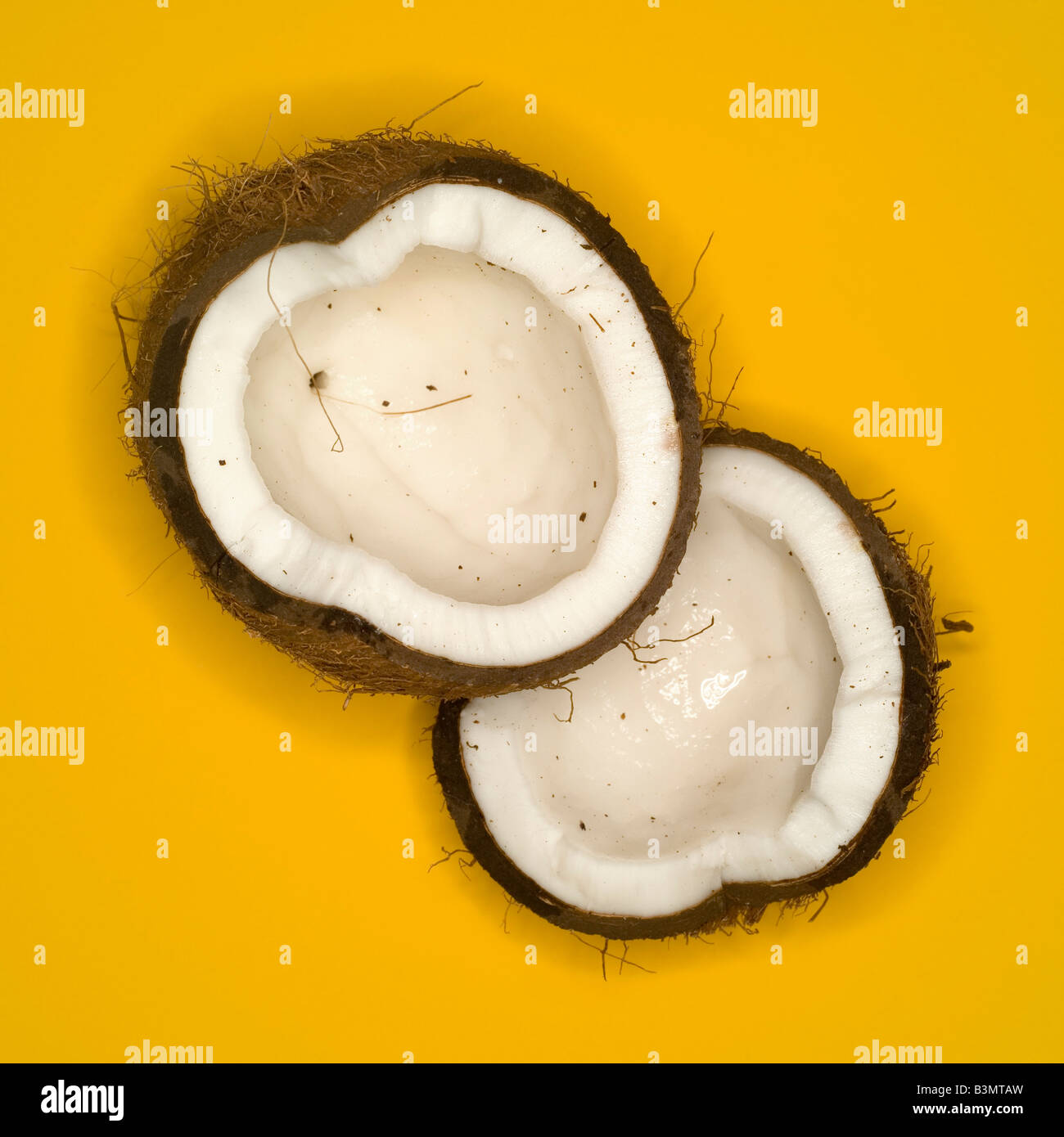 Coconut split in half, elevated view Stock Photo - Alamy