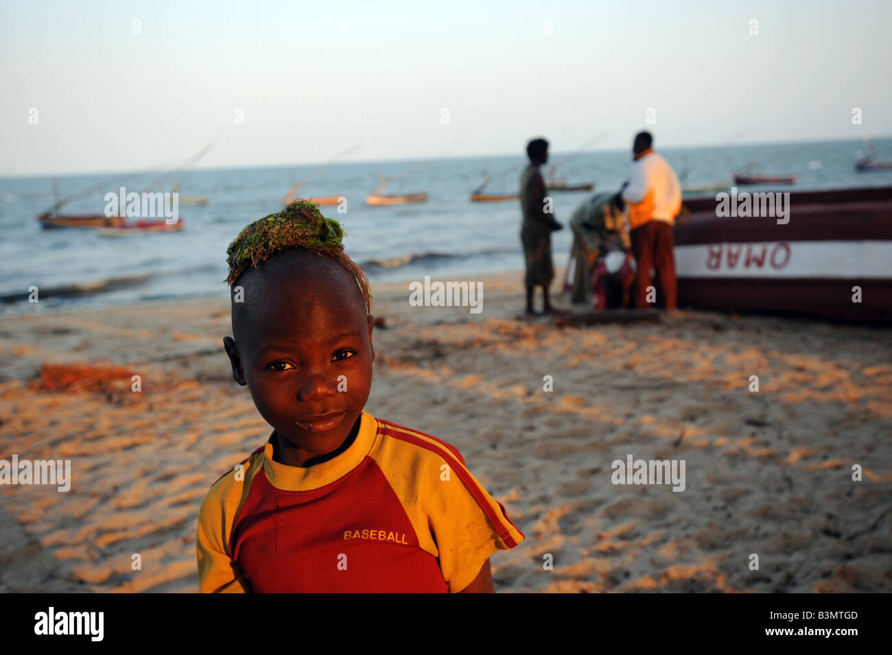 Boy on the beach at Costa do Sol with a seaweed hat, Maputo, Mozambique Stock Photo - Alamy