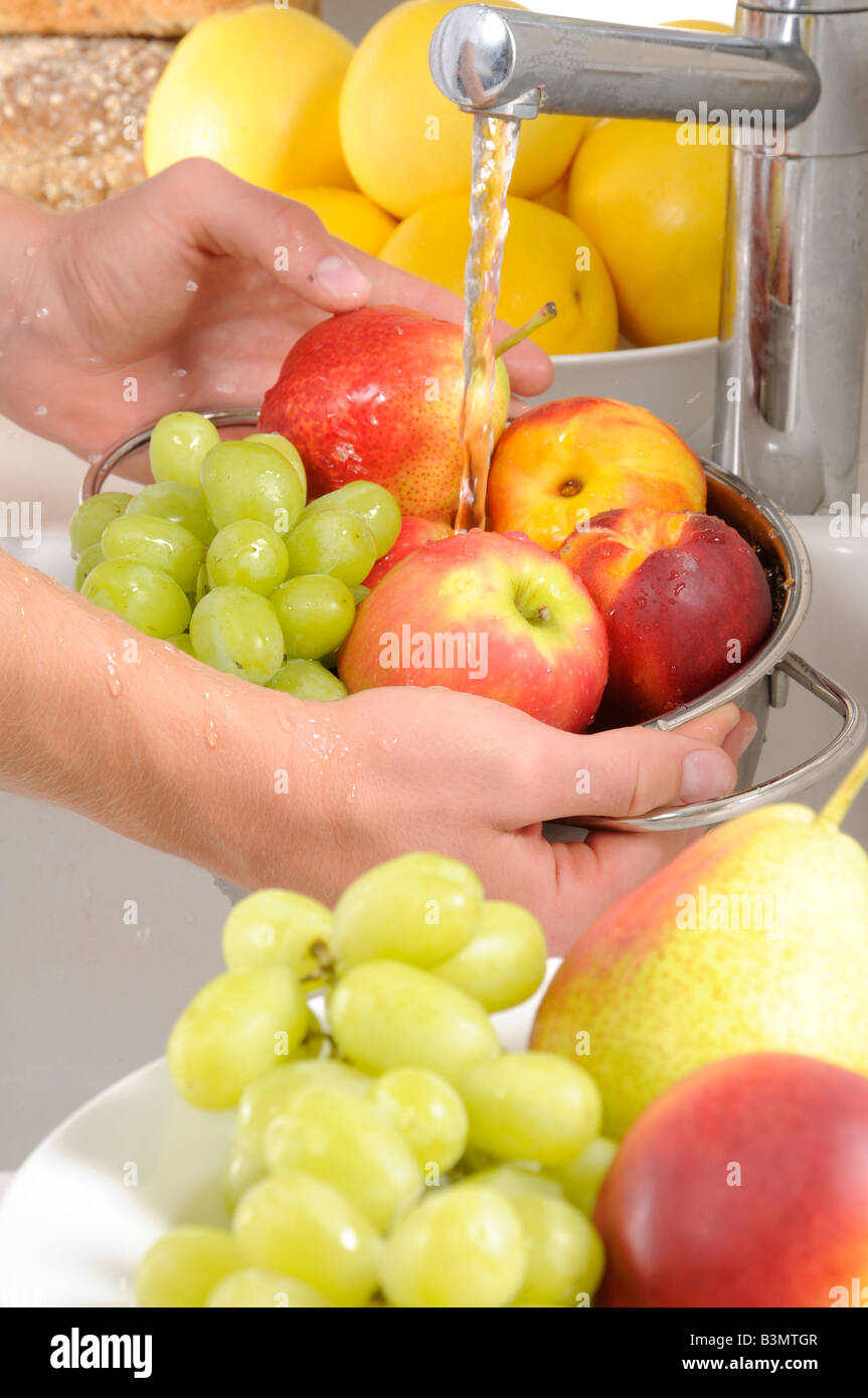 MAN WASHING FRESH FRUIT IN COLLANDER Stock Photo - Alamy