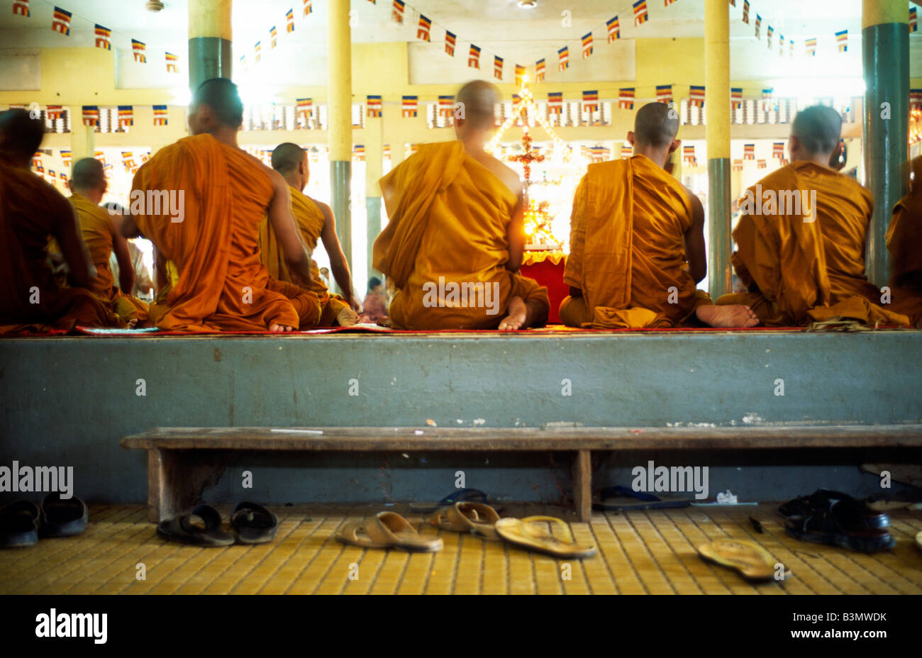 Kneeling monks in temple praying hi-res stock photography and images ...