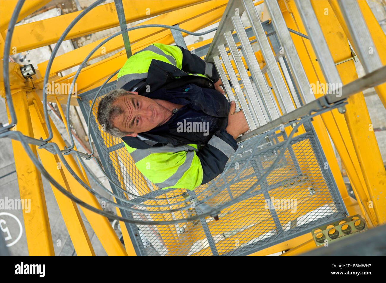Construction worker climbing up inside construction tower crane Stock ...