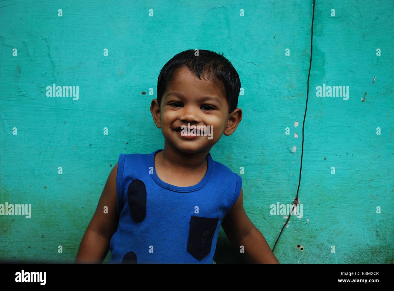 A smiling boy with green backgrounds Stock Photo - Alamy