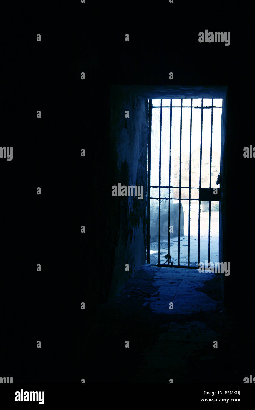 one secluded prison cell door in dark black room Stock Photo - Alamy