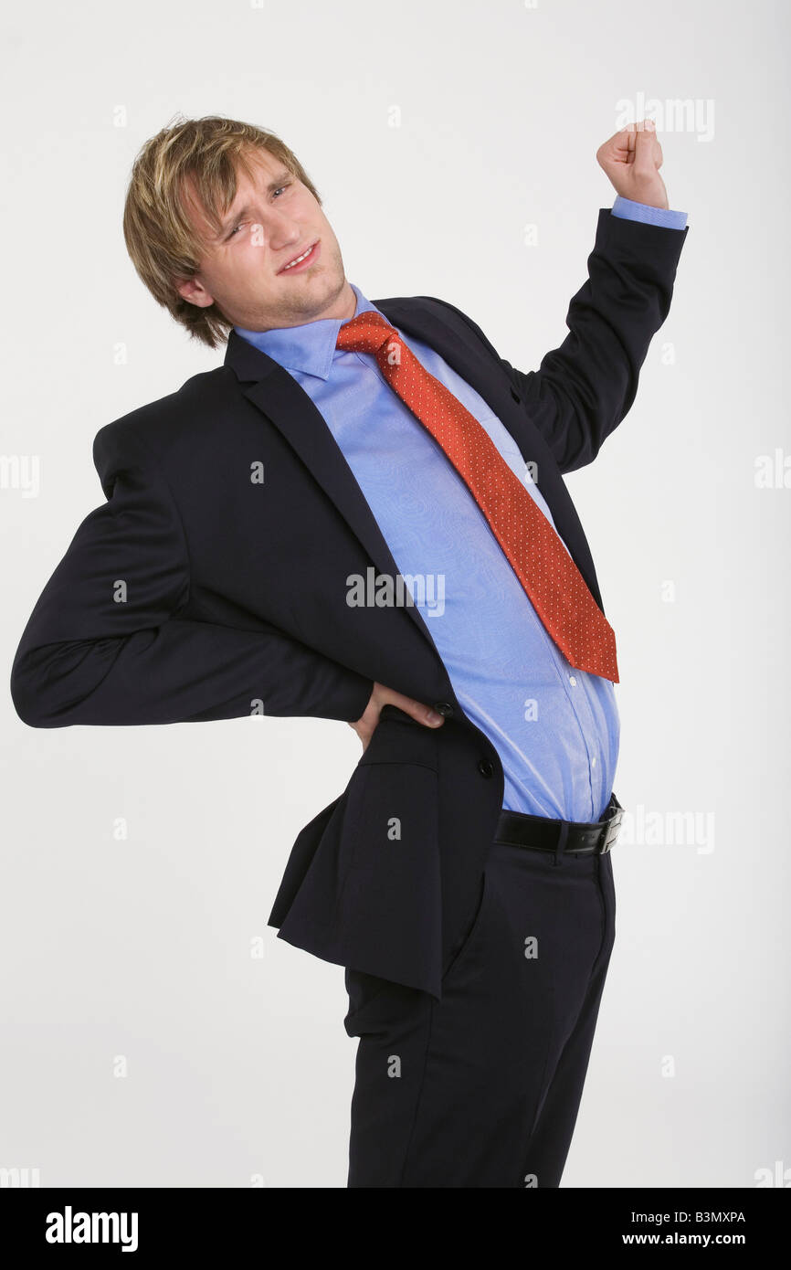 Young businessman suffering from backache Stock Photo - Alamy