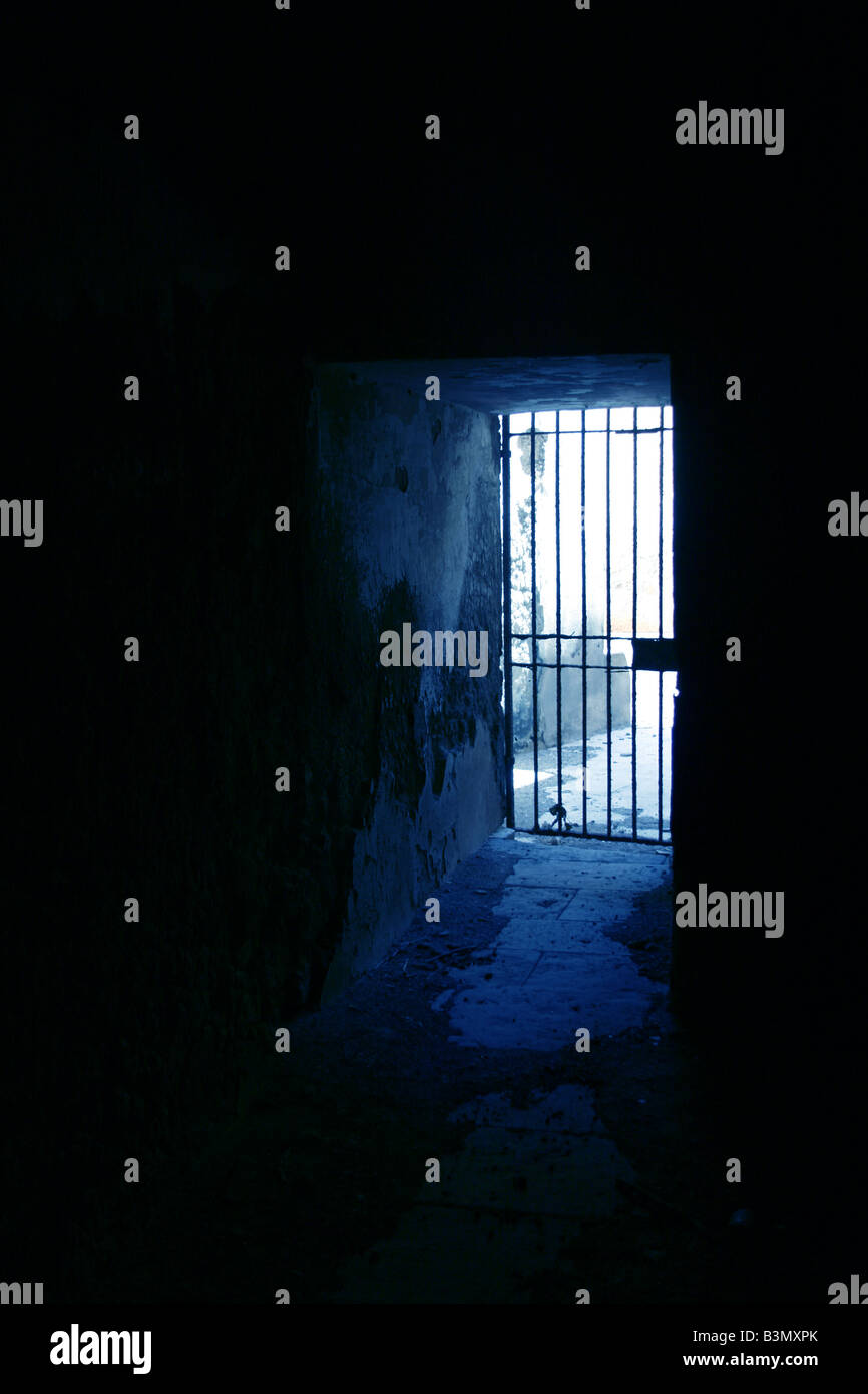 one secluded prison cell door in dark black room Stock Photo - Alamy