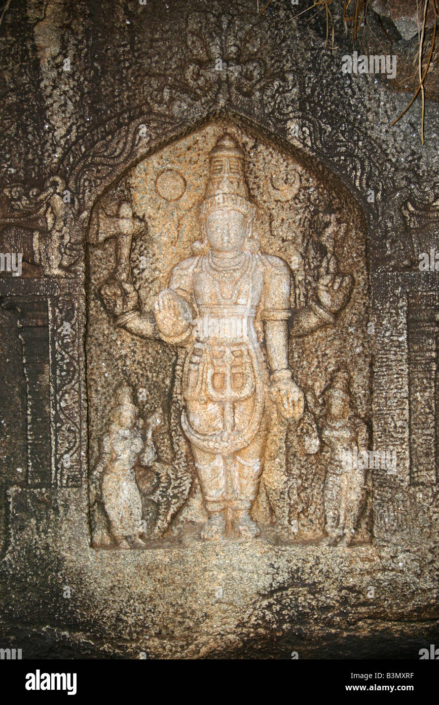 The figure of an ancient Hindu deity in one of the rock temples close ...