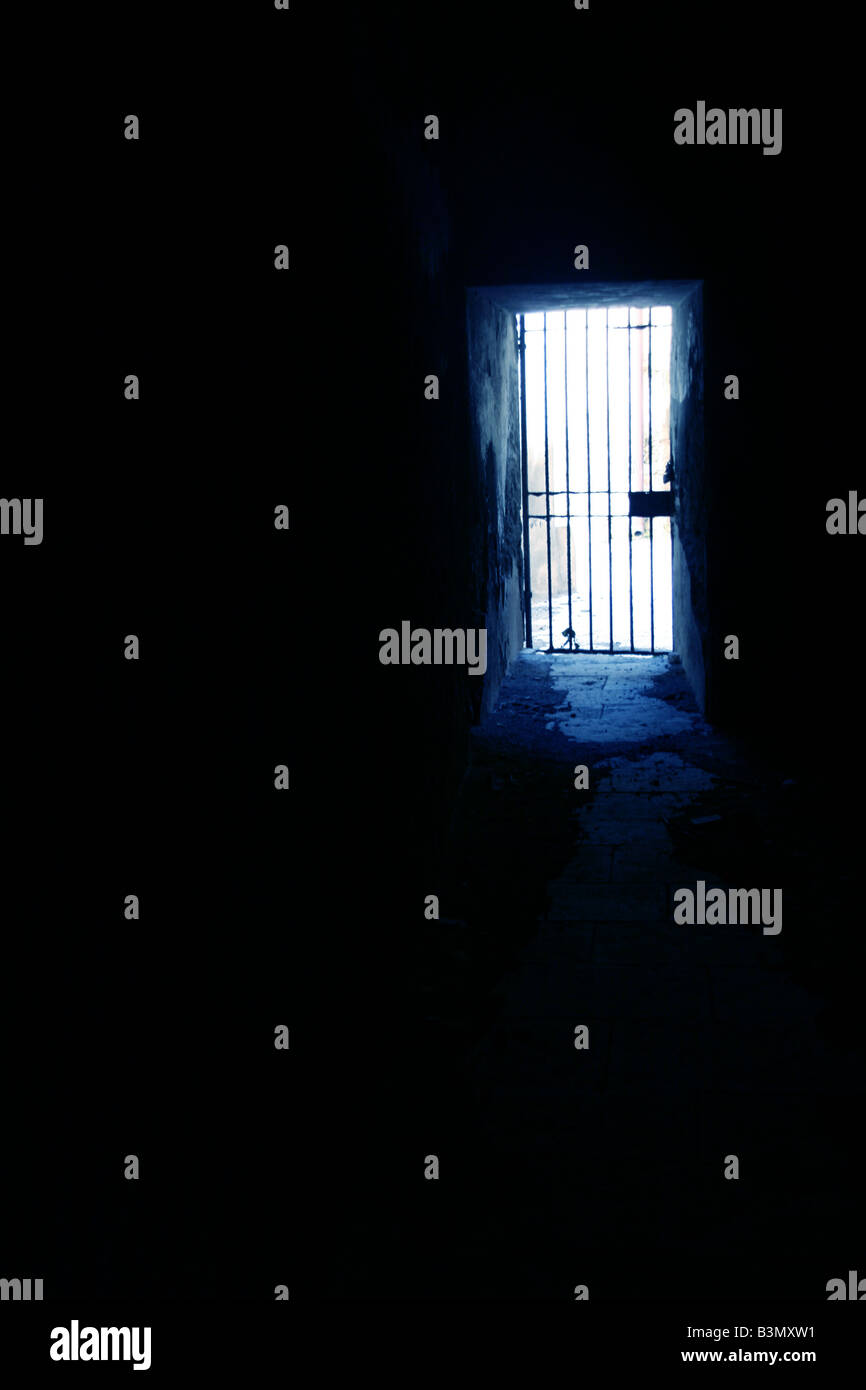 one secluded prison cell door in dark black room Stock Photo - Alamy