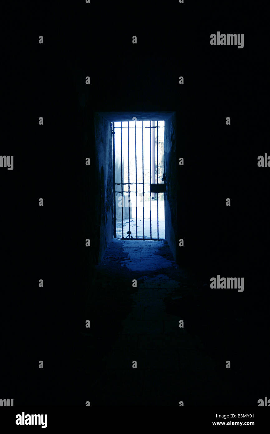 one secluded prison cell door in dark black room Stock Photo - Alamy