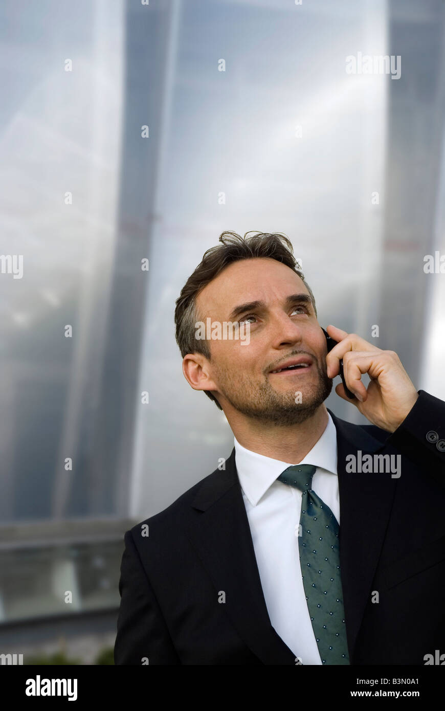 Germany, Bavaria, Businessman using mobile phone, portrait Stock Photo ...