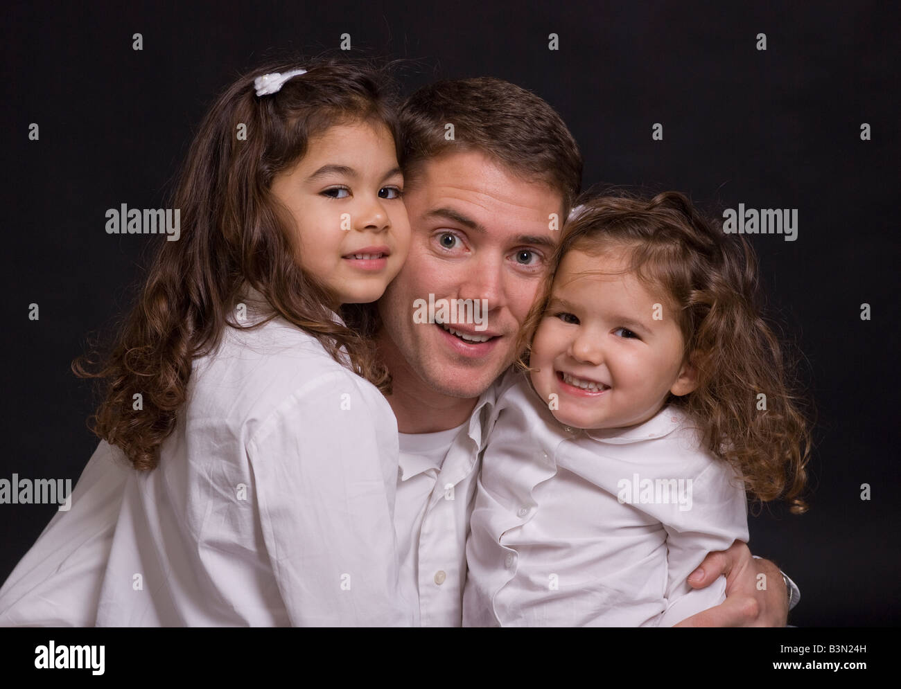 A young father and his two small children Family love caring Stock ...