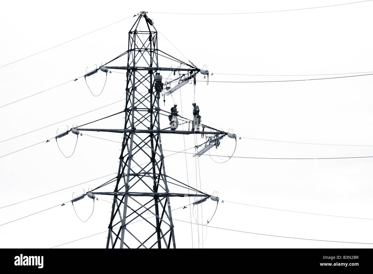 men working on an elecricity pylon Stock Photo - Alamy