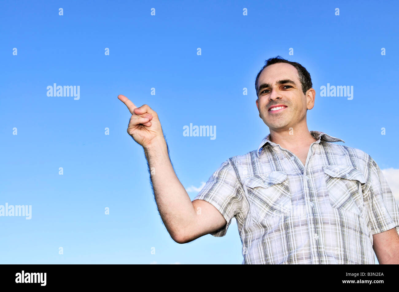 Happy middle aged man gesturing on blue sky background Stock Photo - Alamy