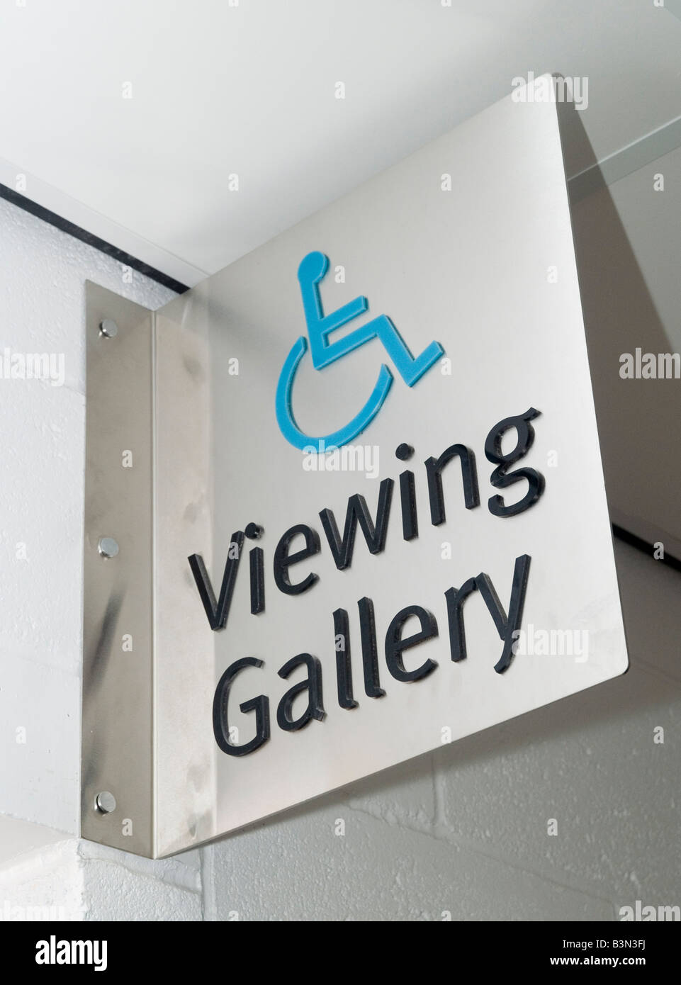 A metal sign on the wall showing disabled access to the Viewing Gallery ...