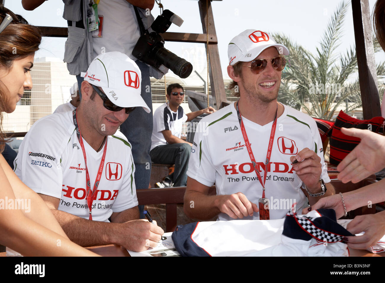 Jensen Button and Rubens Barrichello for Honda sign autographs for fans ...