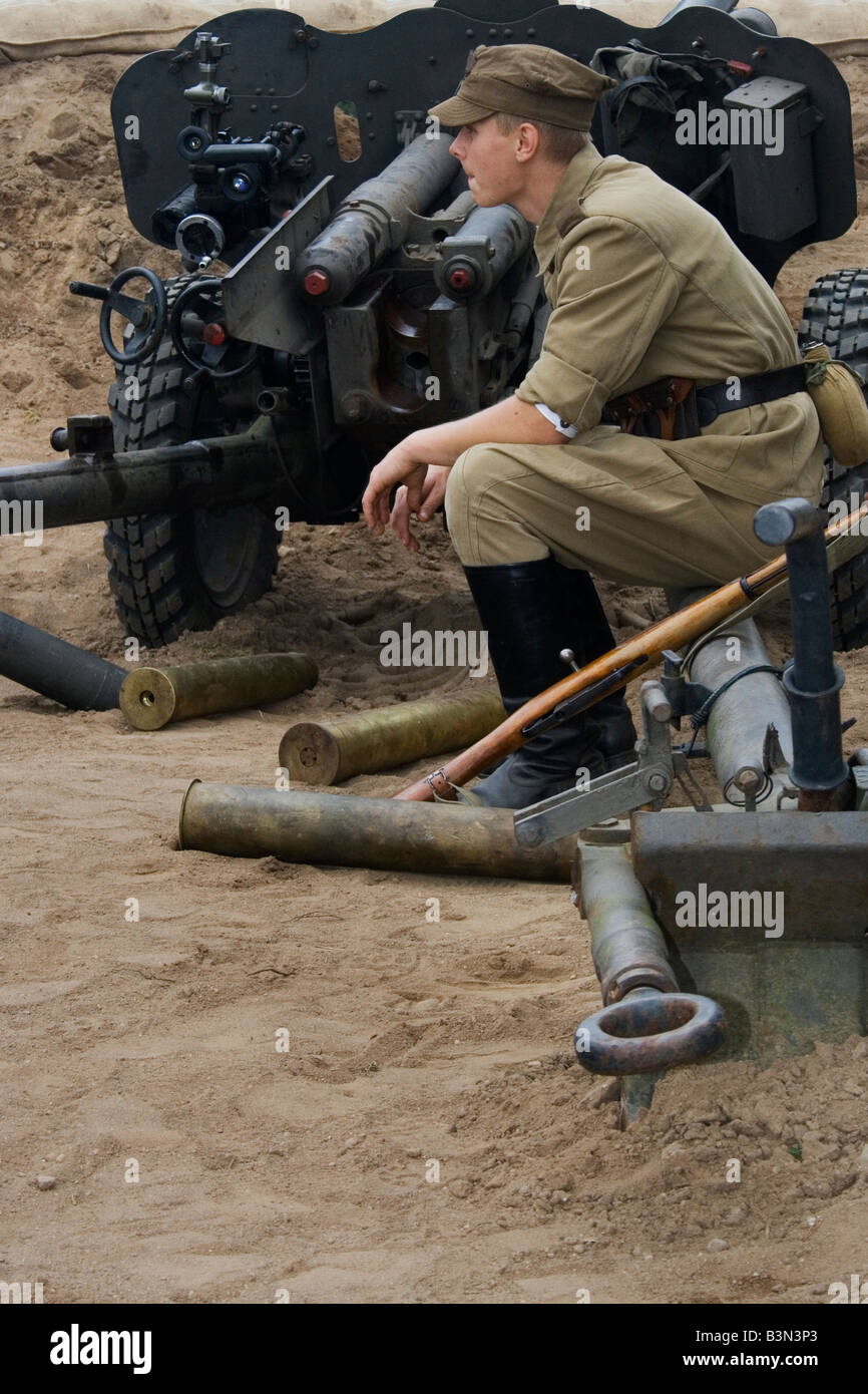 Scene from World War 2 Canon operator waiting for orders in trench ...