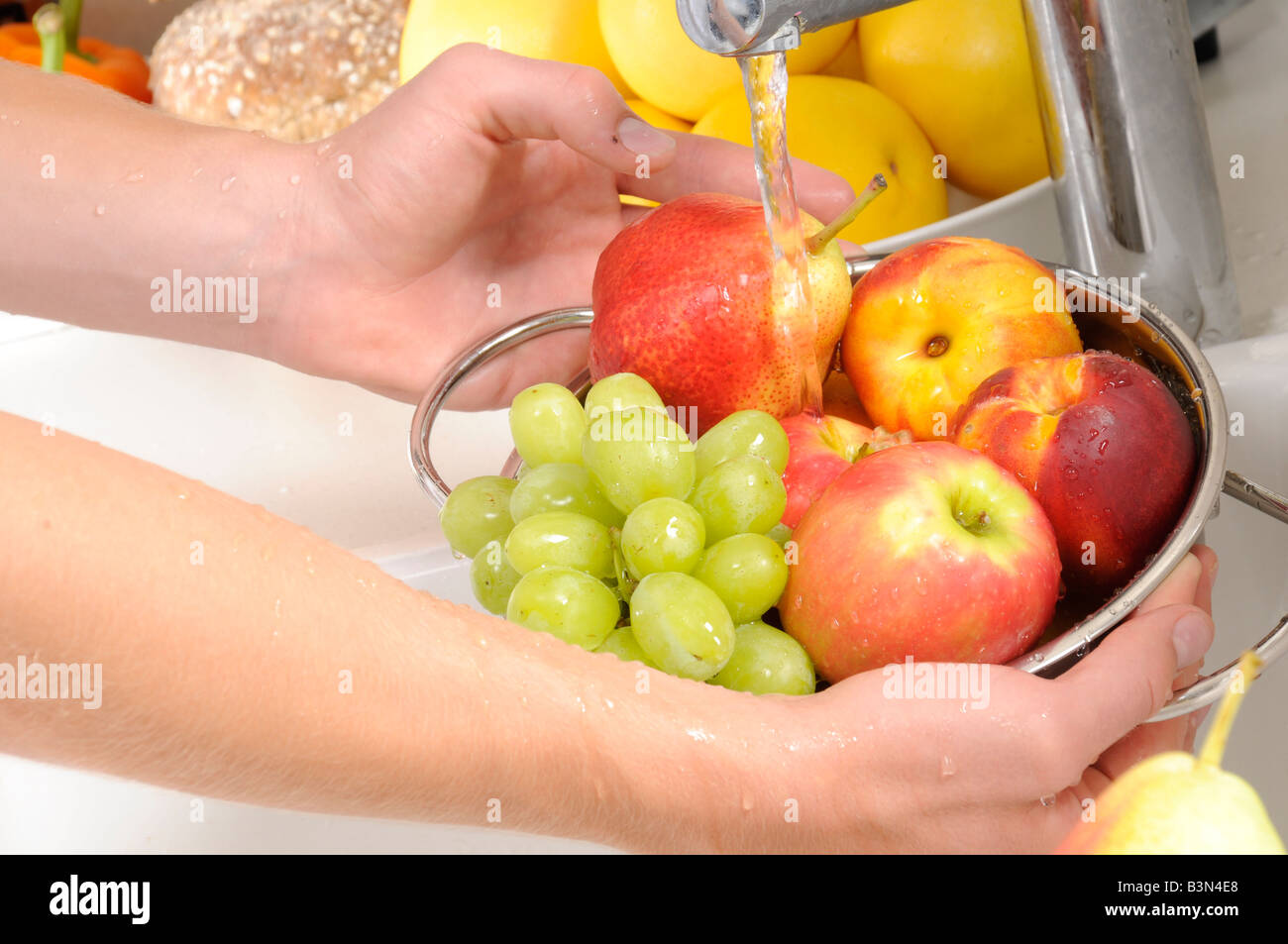 MAN WASHING FRESH FRUIT IN COLLANDER Stock Photo - Alamy