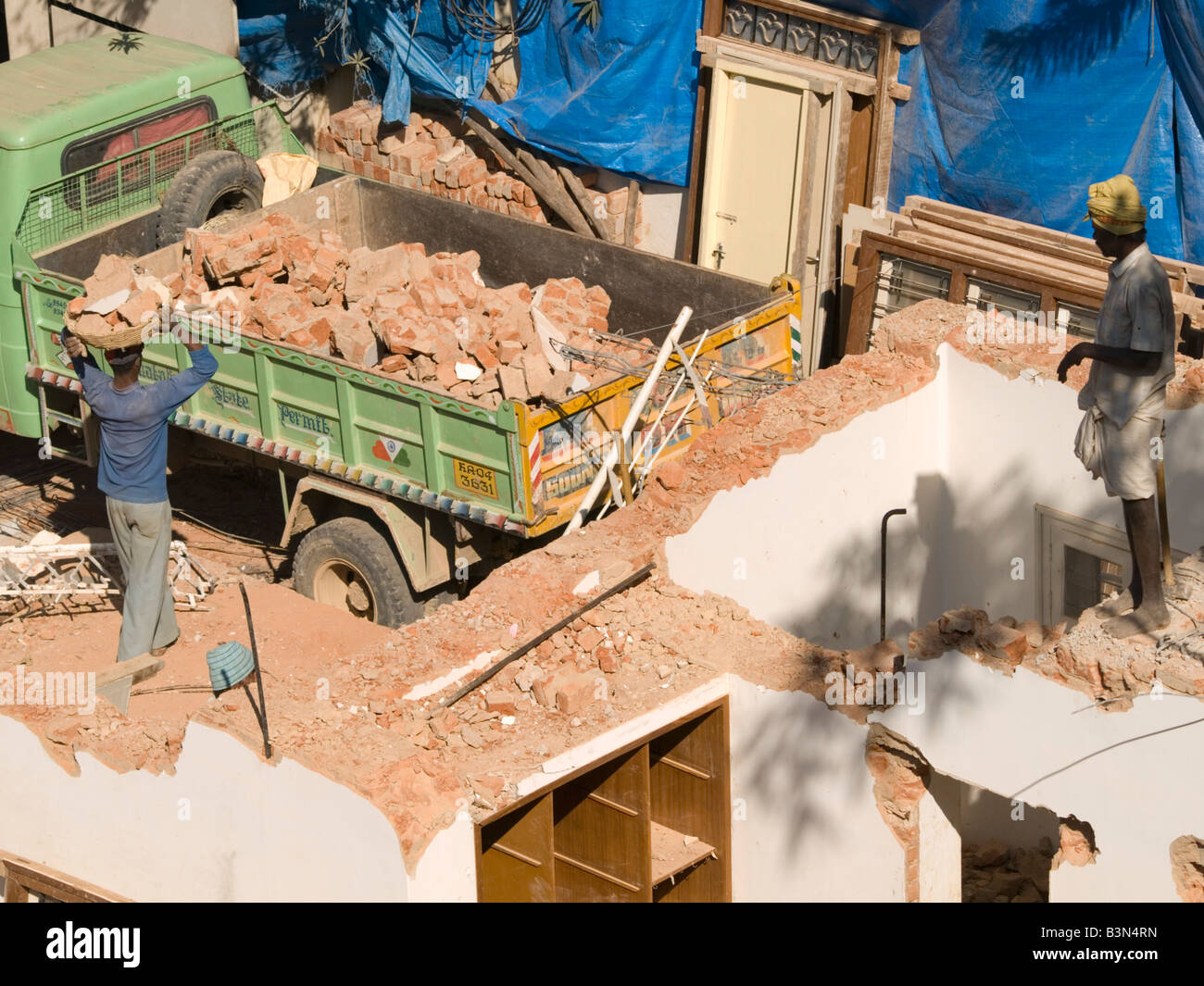 Laborers manually demolish a house Stock Photo - Alamy