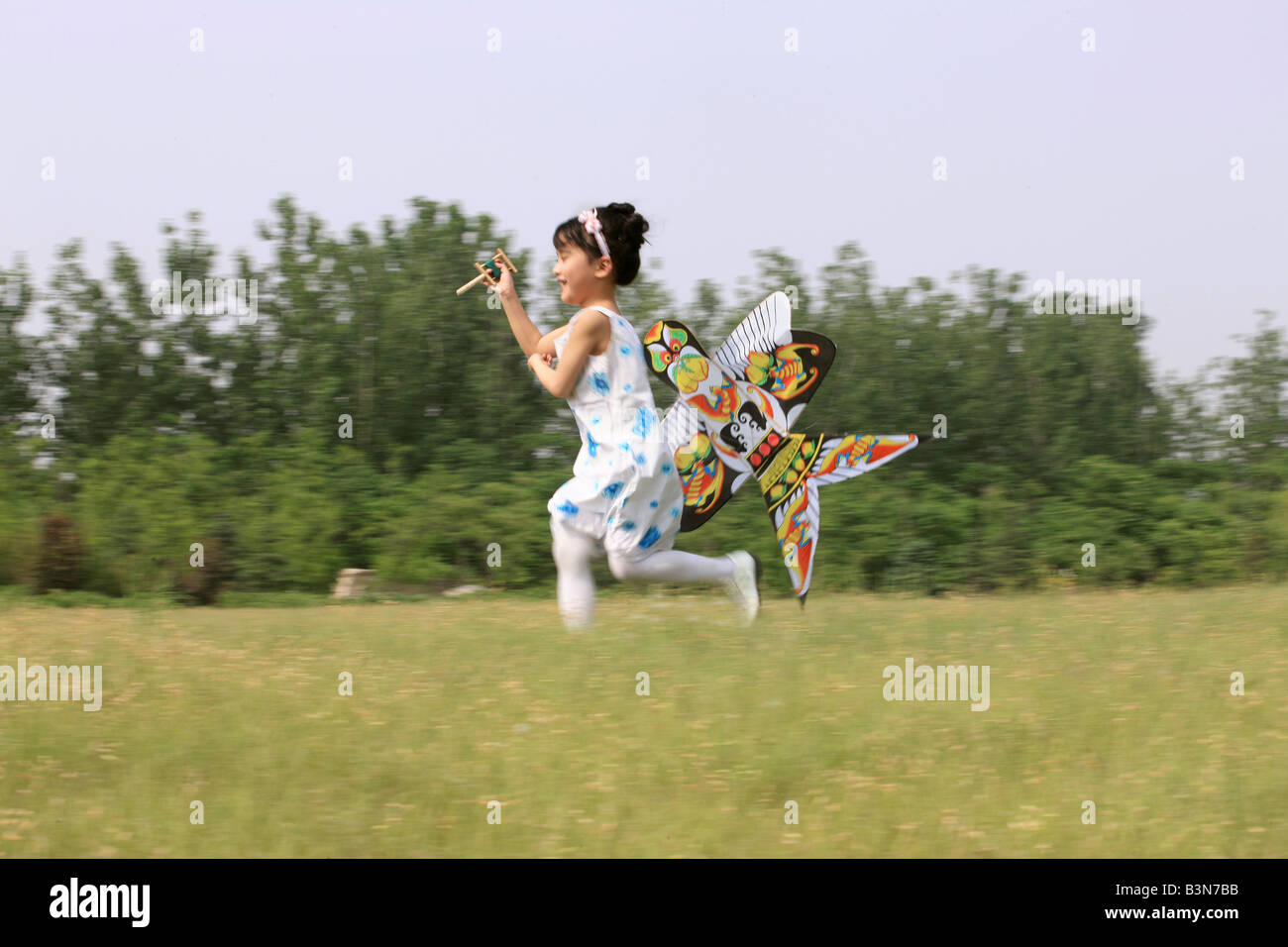 chinese girl flying kite,beijing Stock Photo - Alamy