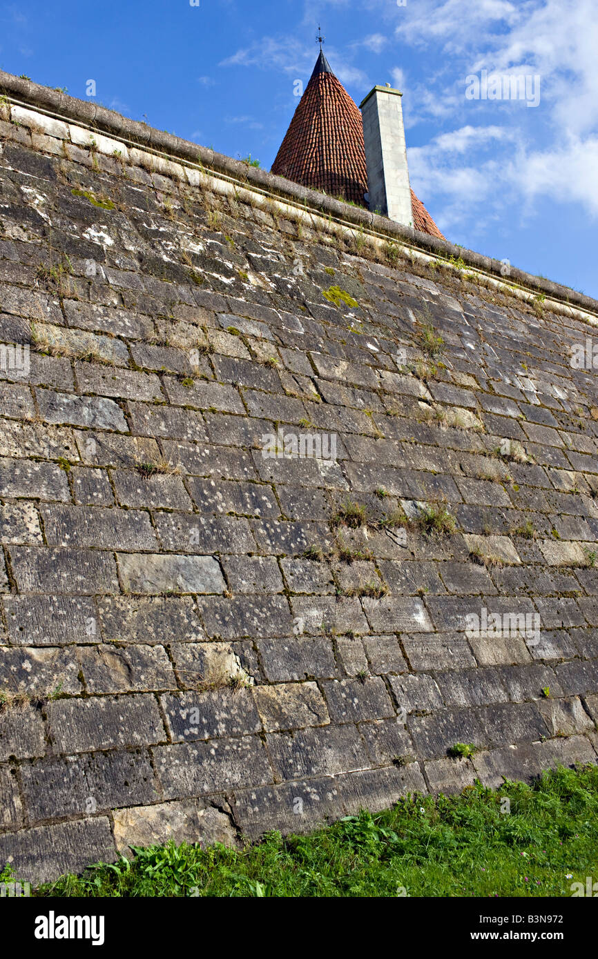 Slope wall of castle with a tower rooftop and a chimney Stock Photo - Alamy