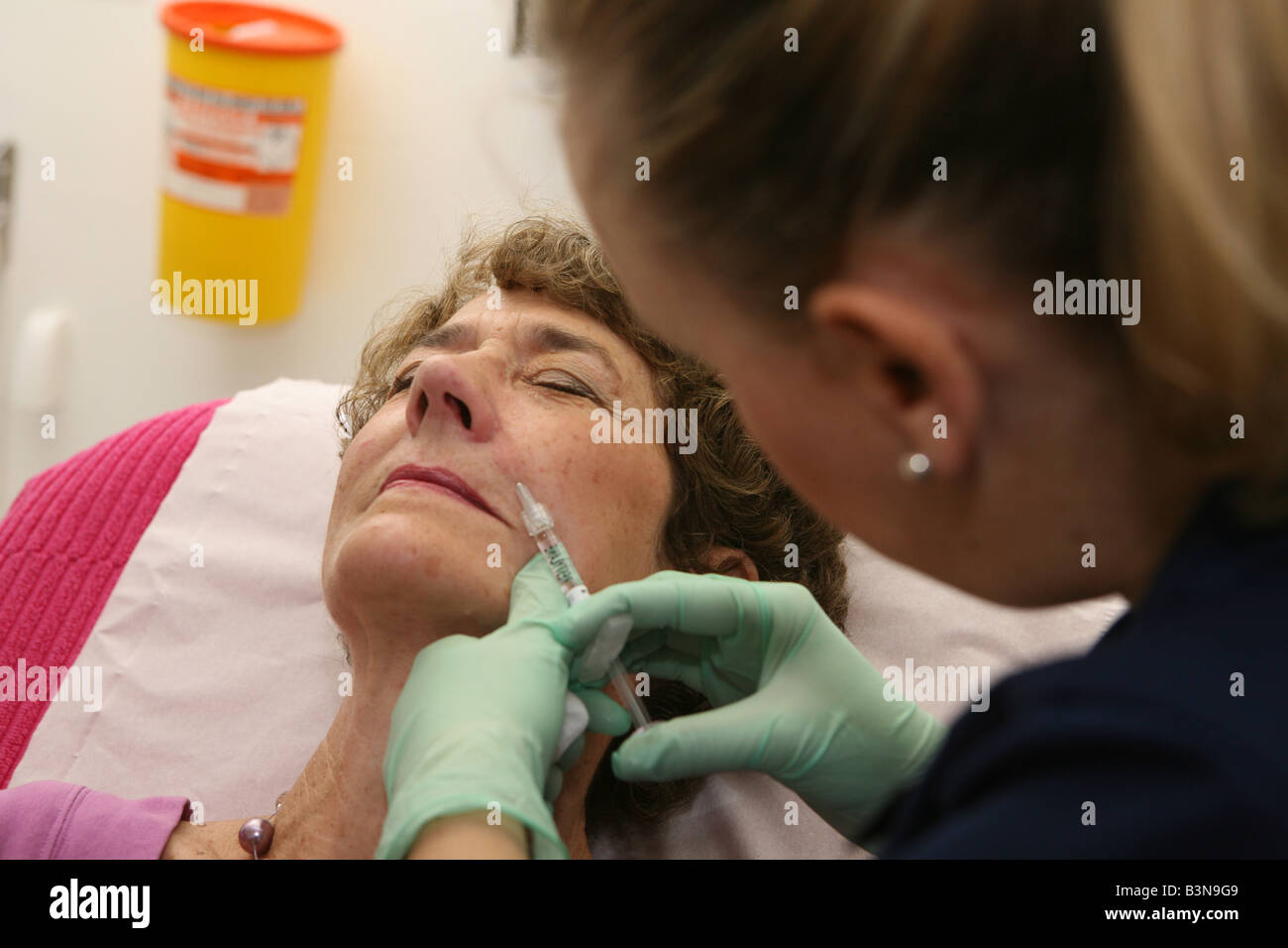 a older woman receiving botox from a beauty technician in a beauty ...