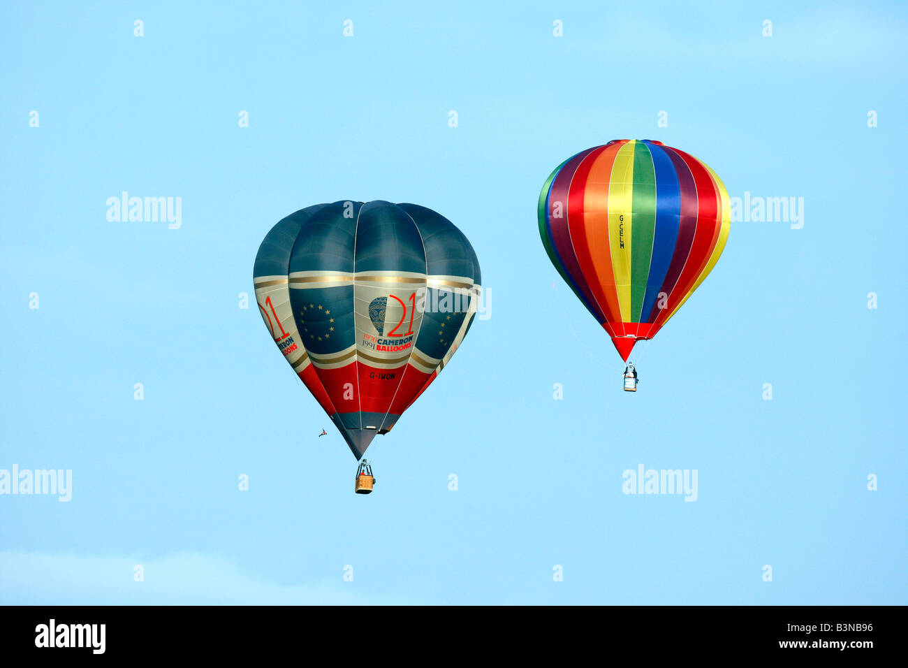 Two colourful hot air balloons against blue sky Stock Photo - Alamy