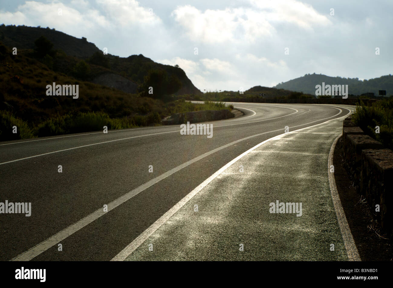 a driving road in southern Spain with a sharp left turn Stock Photo - Alamy