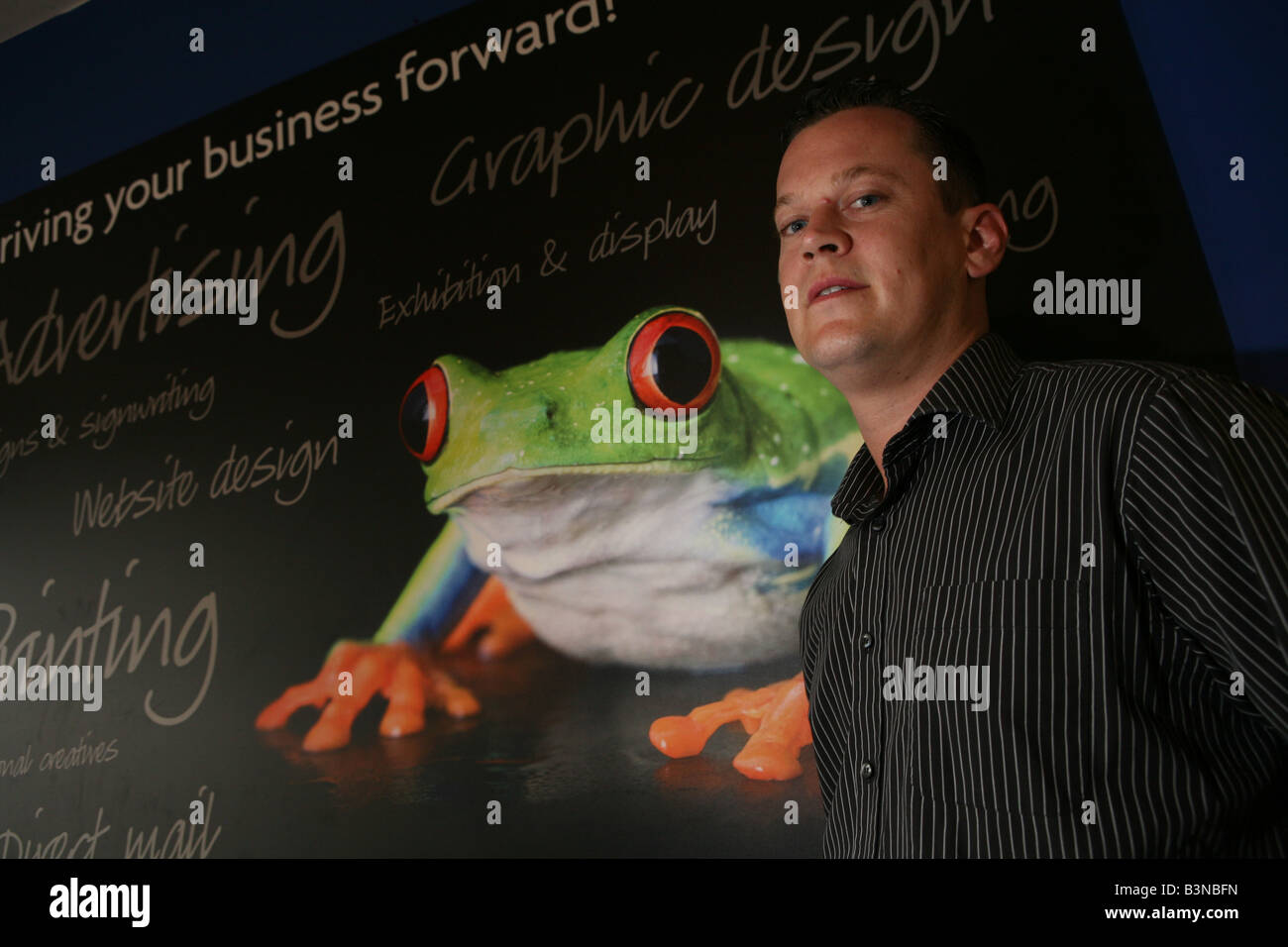 a portrait of a business man standing next to a big green frog Stock ...