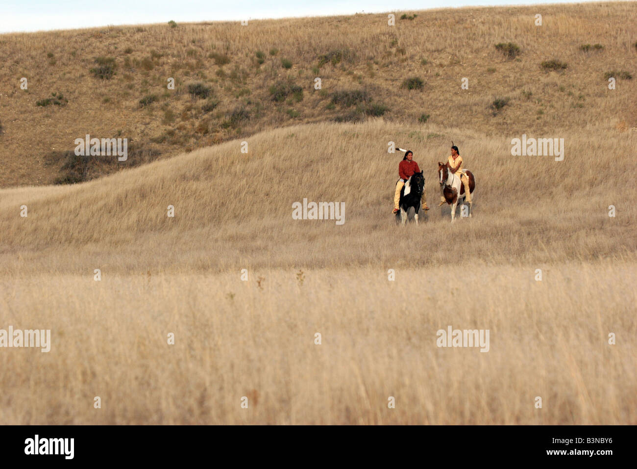 Two Native American Indians on horseback on the Praire of South Dakota ...