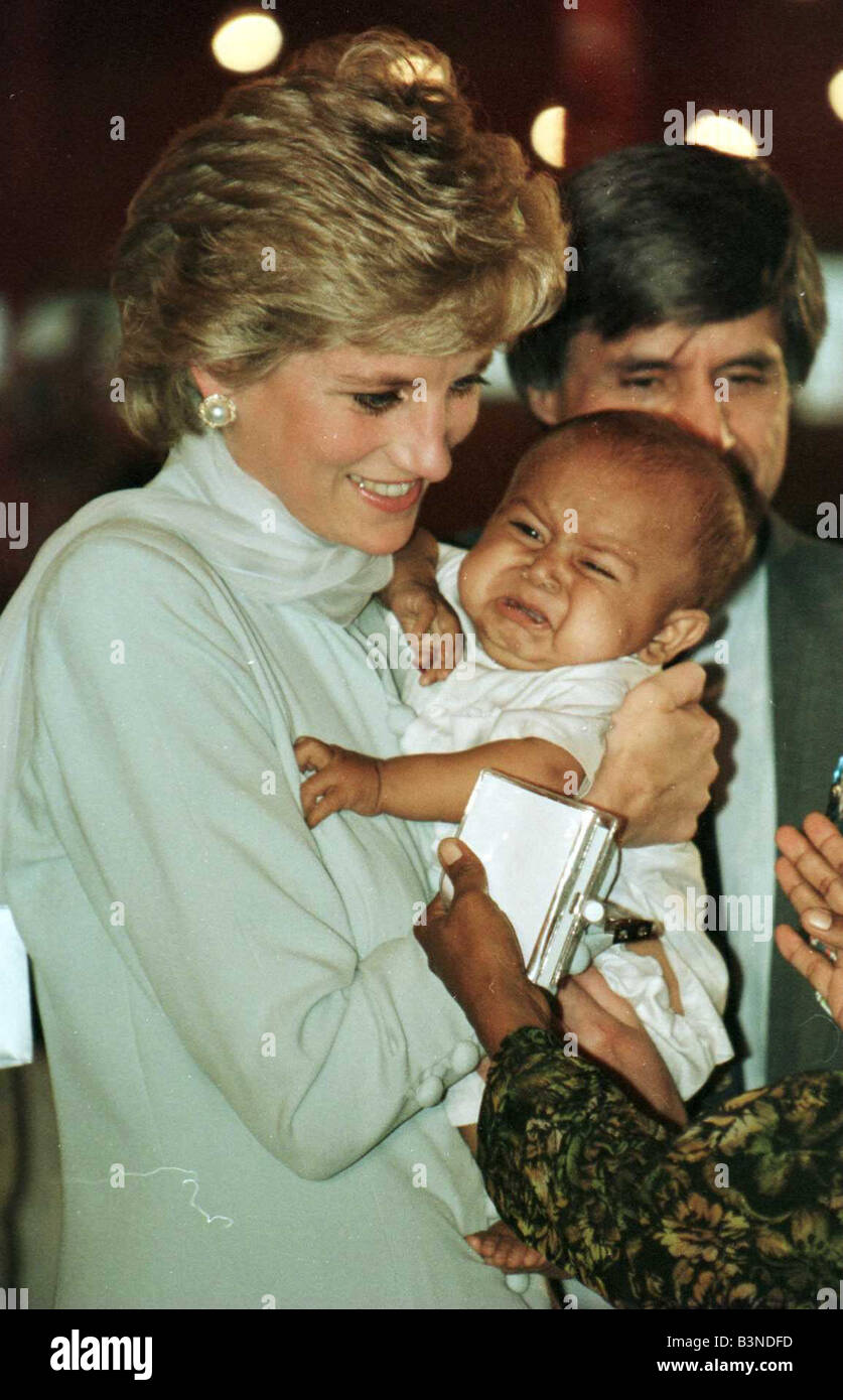 Princess Diana holds a baby during presenting prizes at hospital ...