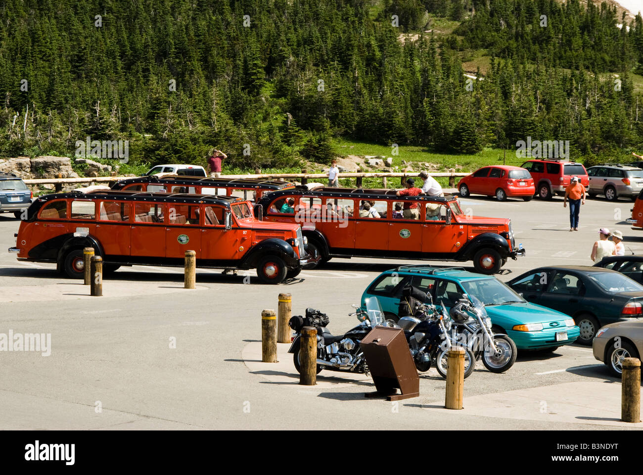 Propane powered red tour buses at Logan Pass in Glacier National Park ...