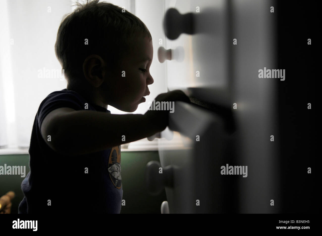curious child peeks in drawer Stock Photo - Alamy