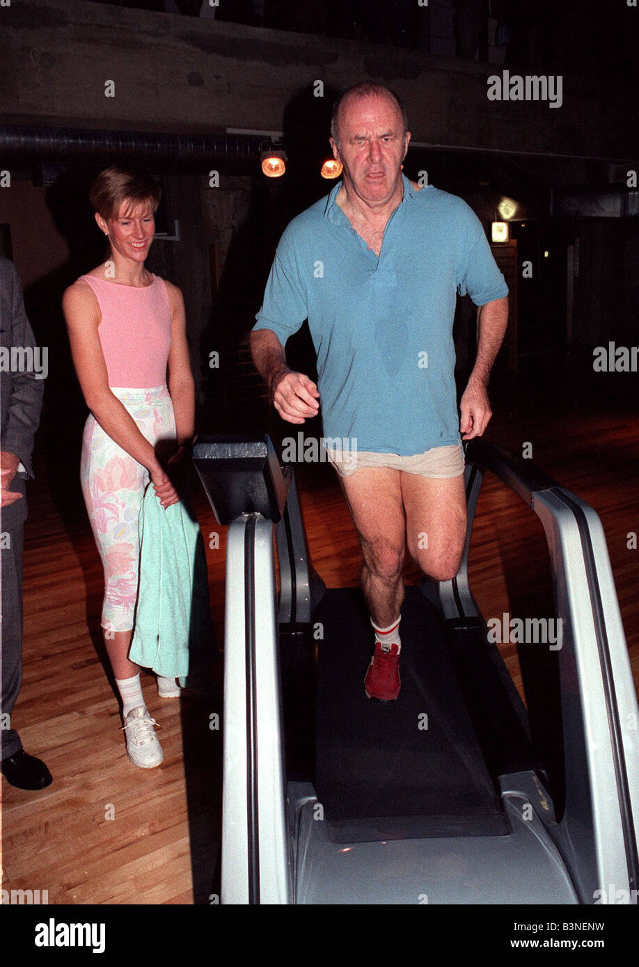 Clive James TV presenter on treadmill February 1990 On running machine ...