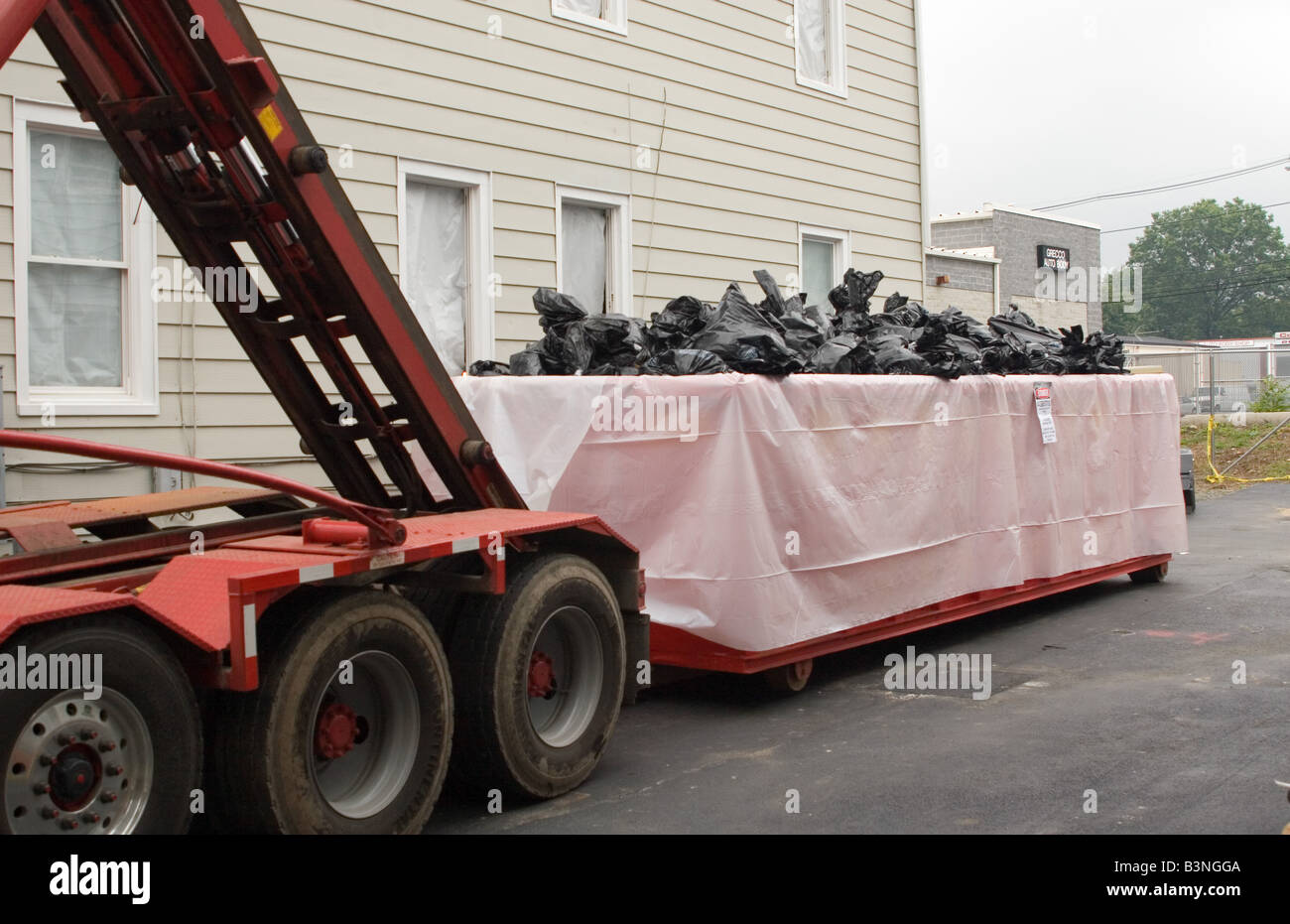 Roll-off box containing asbestos about to be picked up and transported ...