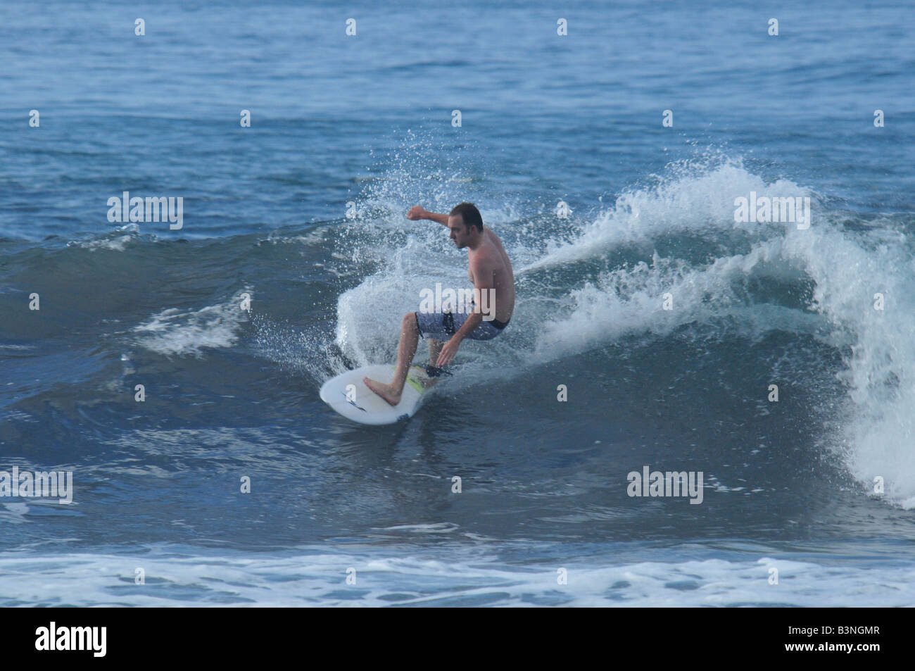 Surfer riding a wave, Kuta Beach, Bali, Indonesia Stock Photo - Alamy