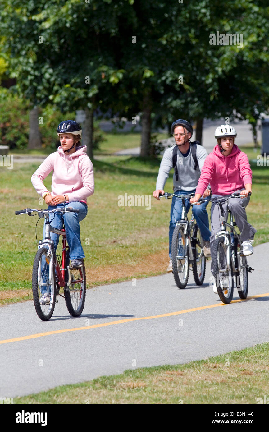 Bicyclists ride along the Seawall path in Stanley Park at Vancouver ...