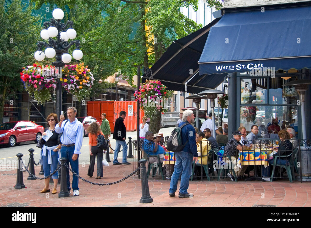 People dine at a sidewalk cafe in the Gastown area of Vancouver British ...