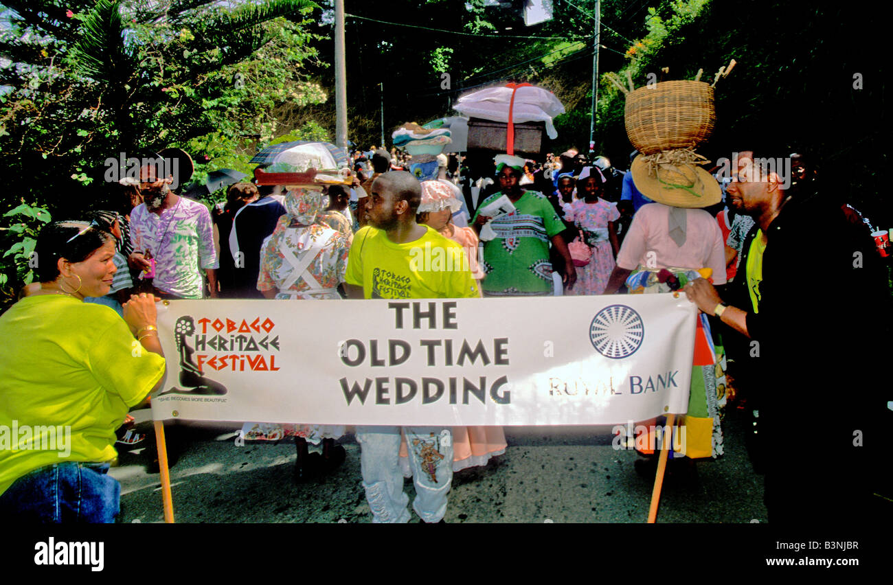 Wedding party holds banner marching the streets of Moriah village old ...