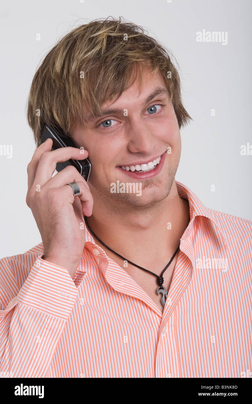 Young man using mobile phone, portrait Stock Photo - Alamy