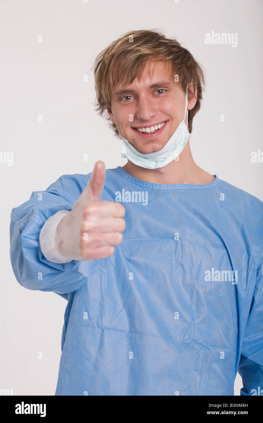 Young man wearing mask, thumbs up Stock Photo - Alamy