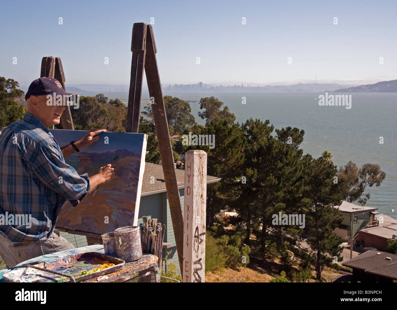 Richmond California An artist paints a landscape from his perch above ...