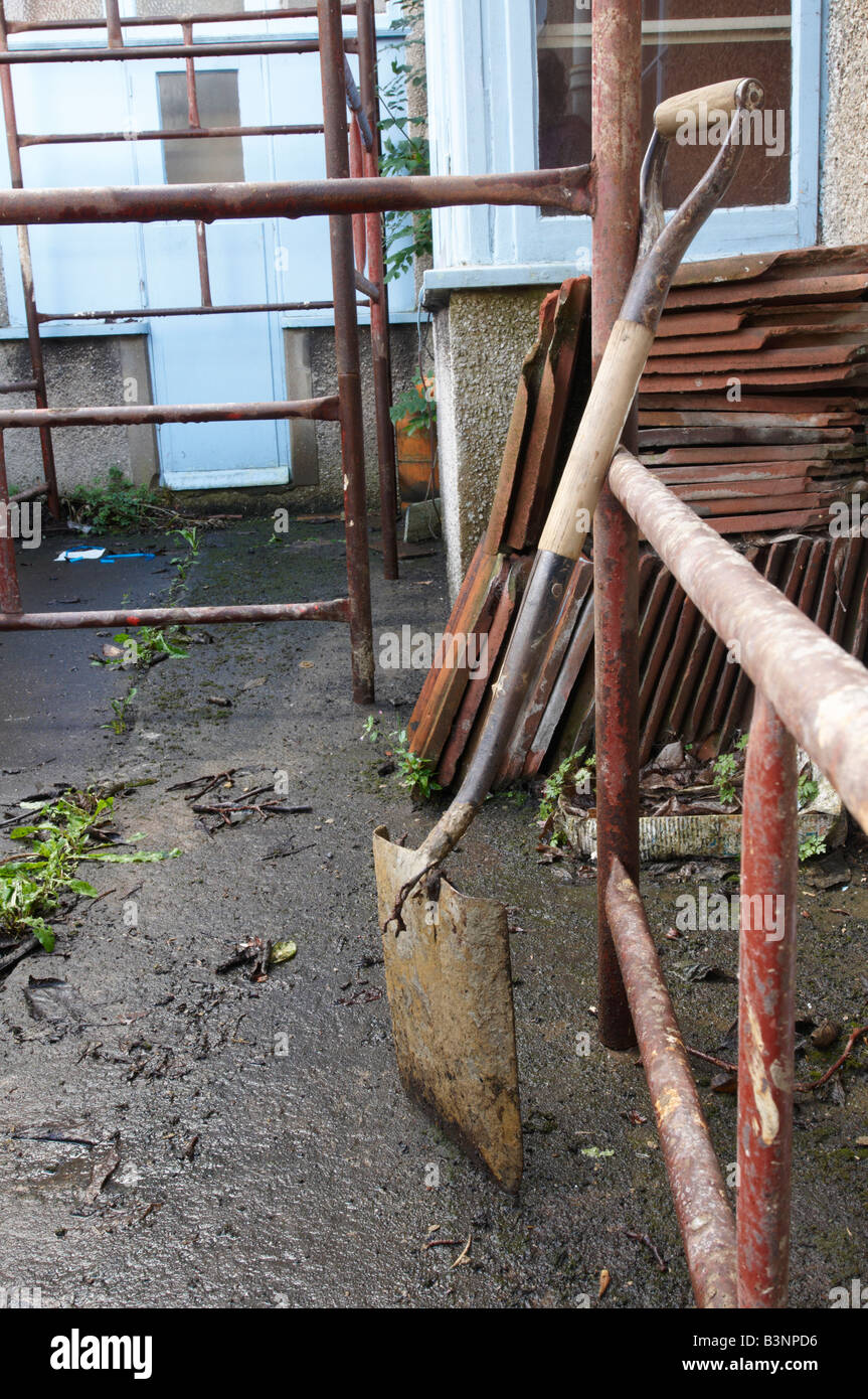 Scaffolding in back garden for building work with spade Stock Photo - Alamy