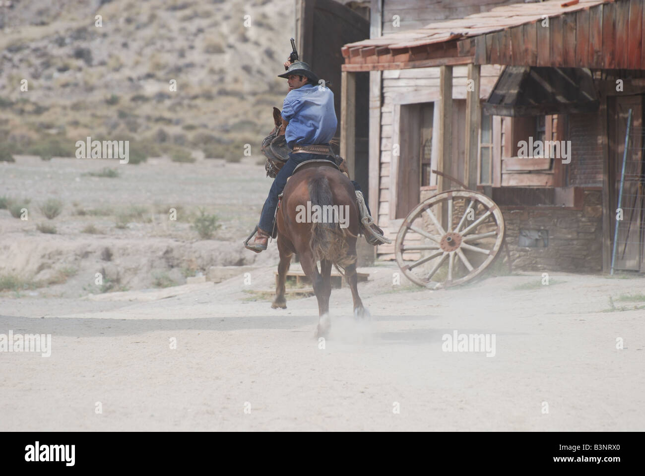 Cowboy riding horse in the western town hi-res stock photography and ...