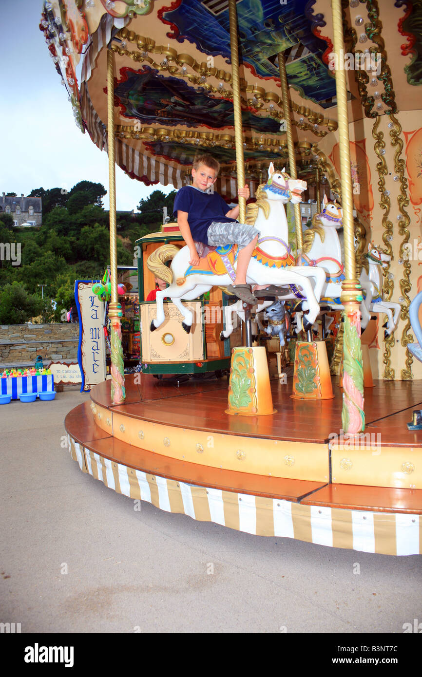 9 year old Boy on carousel (roundabout) in St Cast le Guildo, Cotes d ...