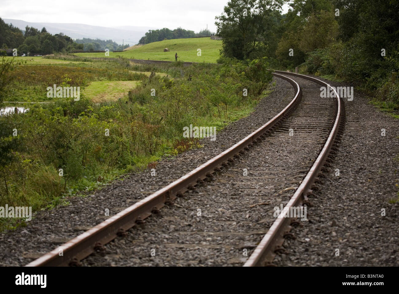 A railtrack in County Durham, England. The rails curve to the left ...