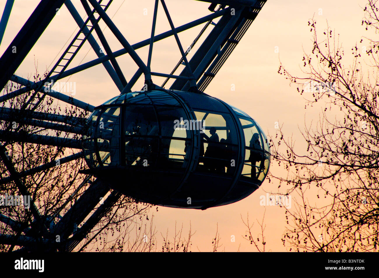 People in London Eye capsule silhouetted against sunset London Stock ...