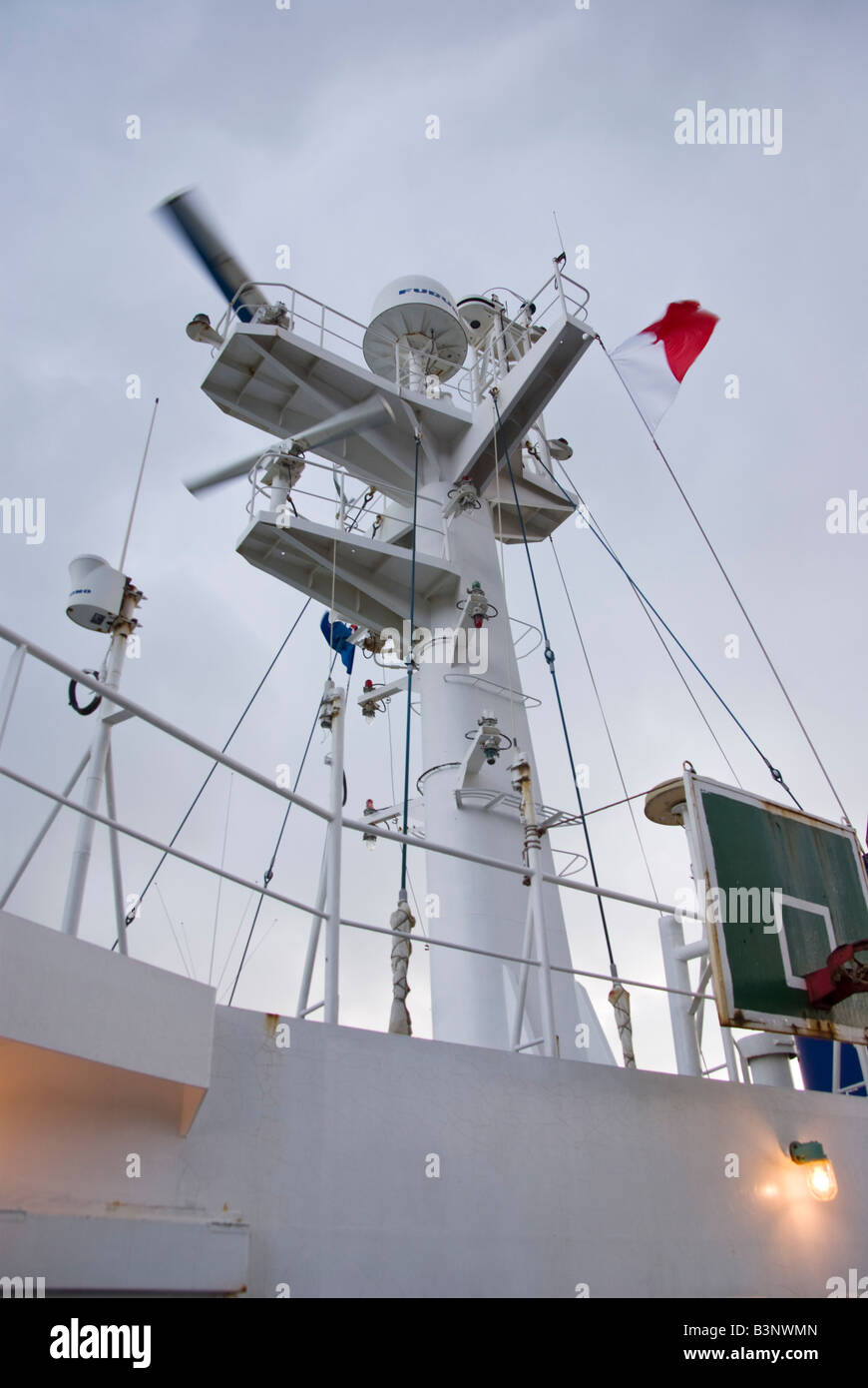 A ship's mast providig support for radar scanners, satellite dome flag ...