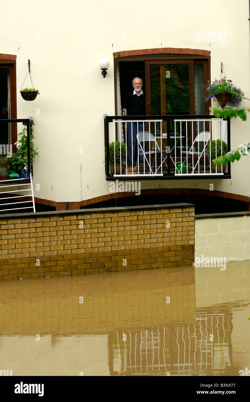 older man surrounded by water waiting for rescue in his house during ...